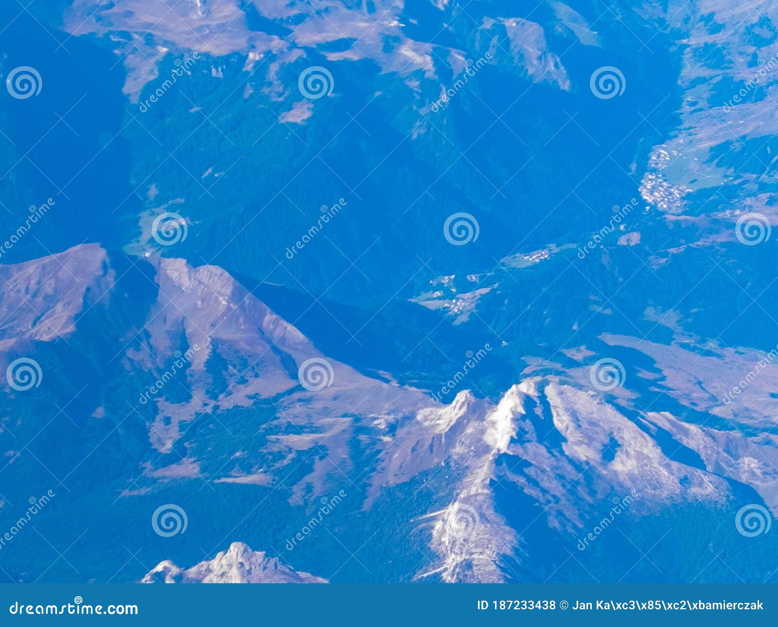 Alps from plane window stock photo. Image of window - 187233438
