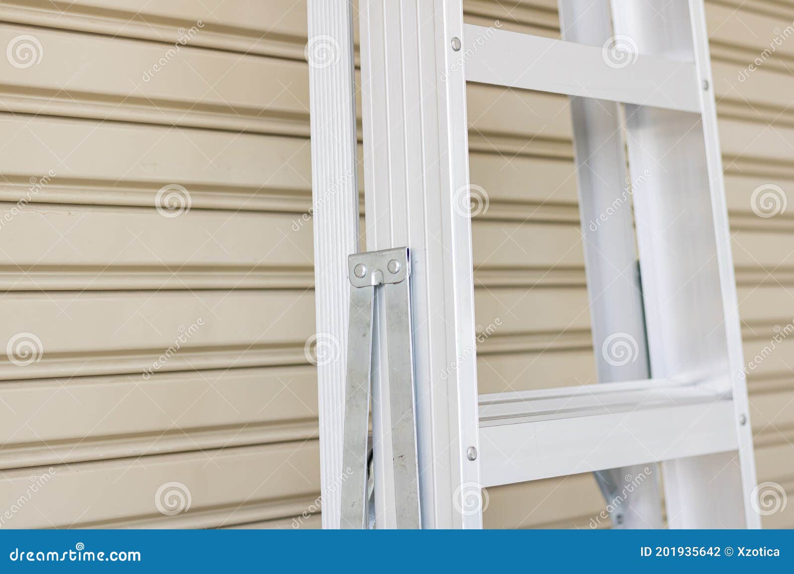 An Aluminum Foldable Ladder on the Wall Stock Photo - Image of platform ...