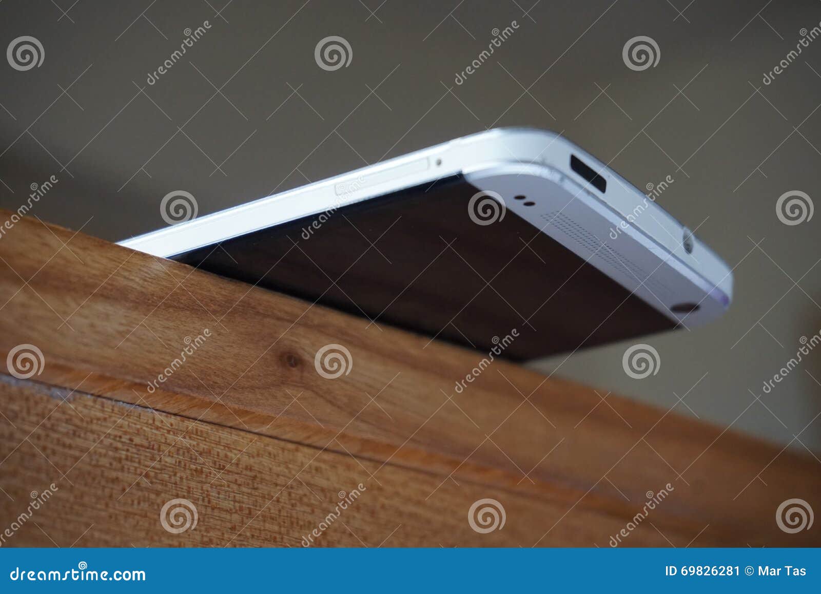 Aluminum Phone Balancing on the Edge of the Wooden Table As a Concept ...