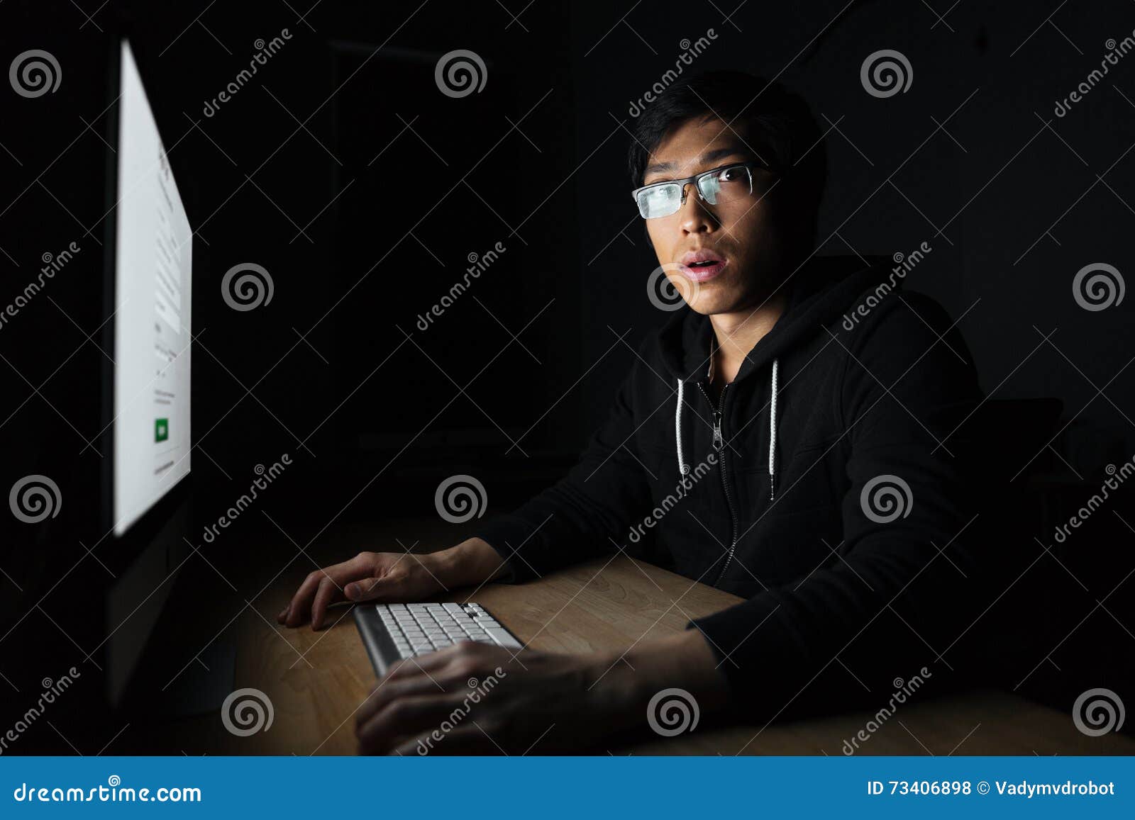 Amazed Asian Young Man Working with Computer in Dark Office Stock Photo ...