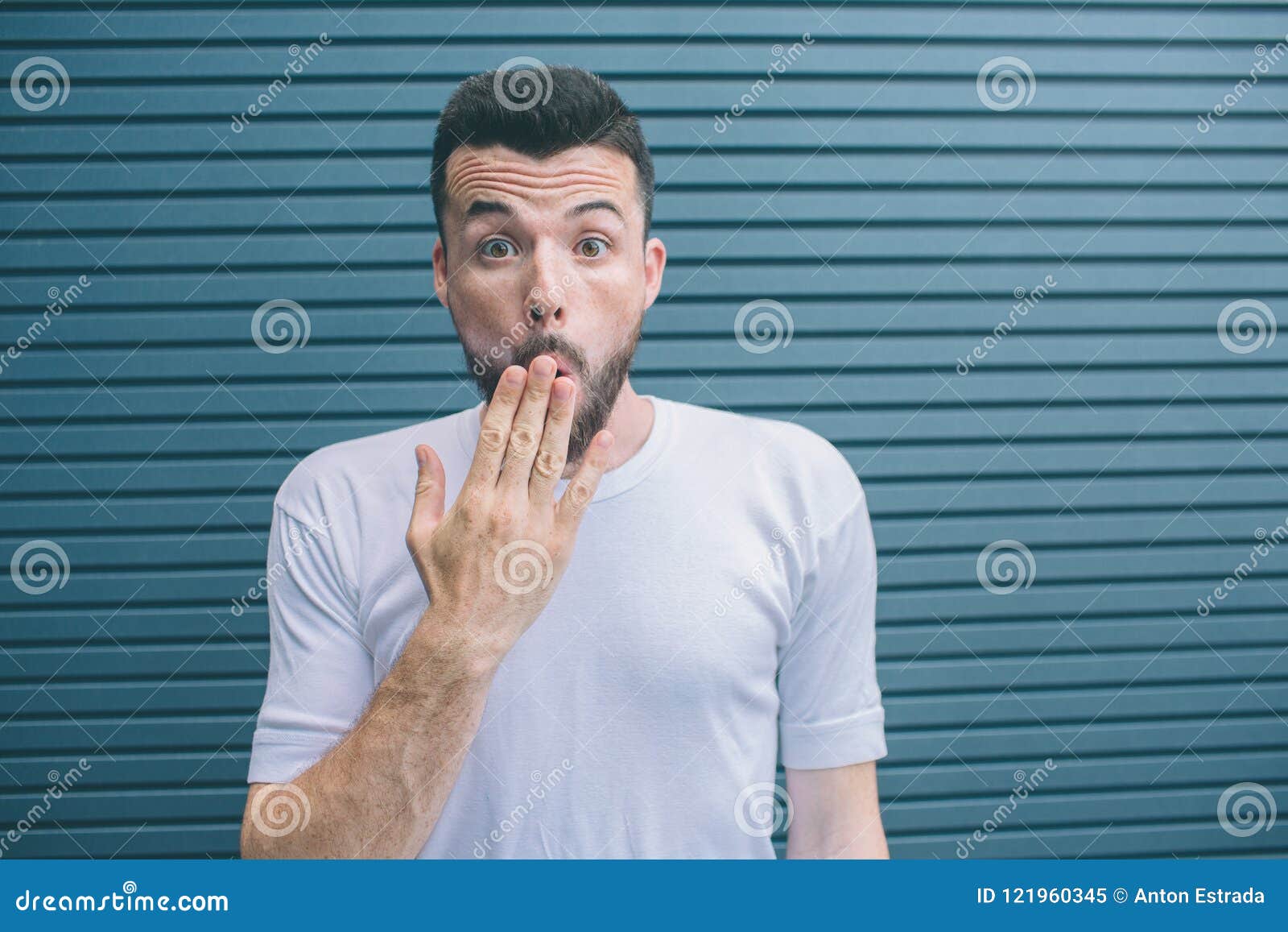 Amazed And Excited Guy Is Looking On Camera He Is Covering Mouth With