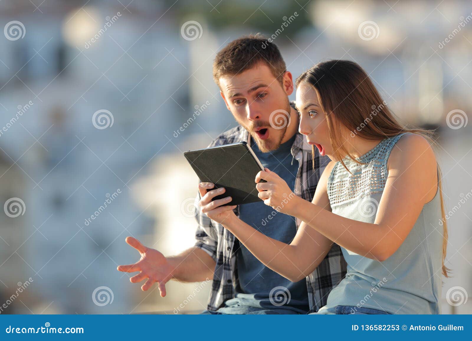 Amazed Friends Finding Online Content on a Tablet Outdoors Stock Image ...