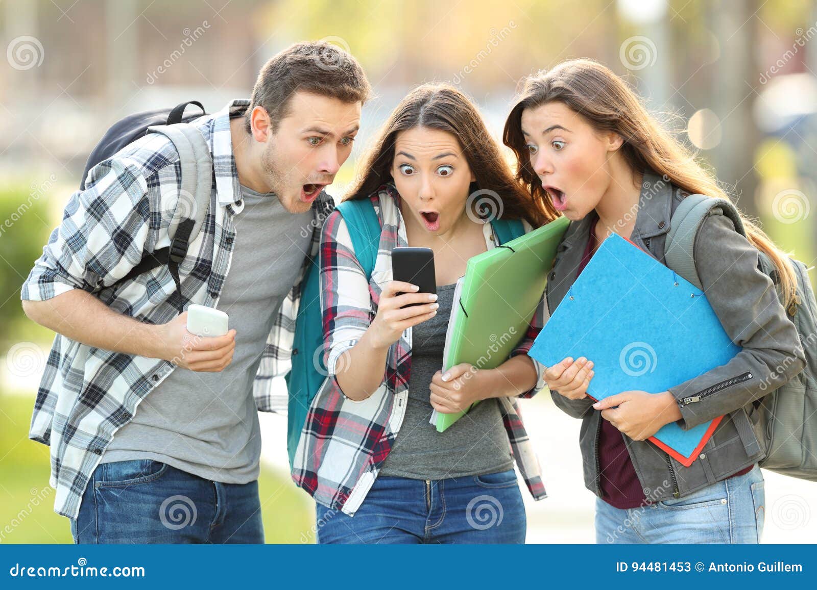 Amazed Students Checking Content on a Phone Stock Image - Image of ...