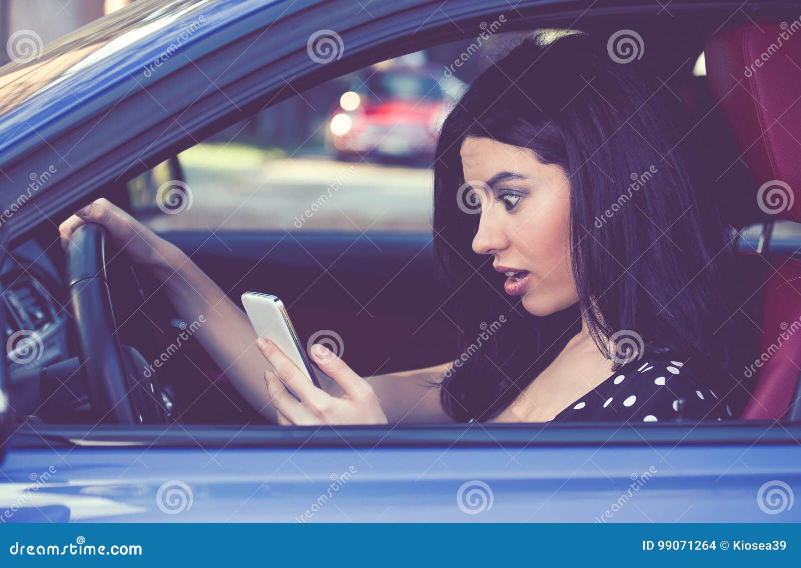 Amazed Woman Distracted Reading a Message on Cellphone Driving a Car ...
