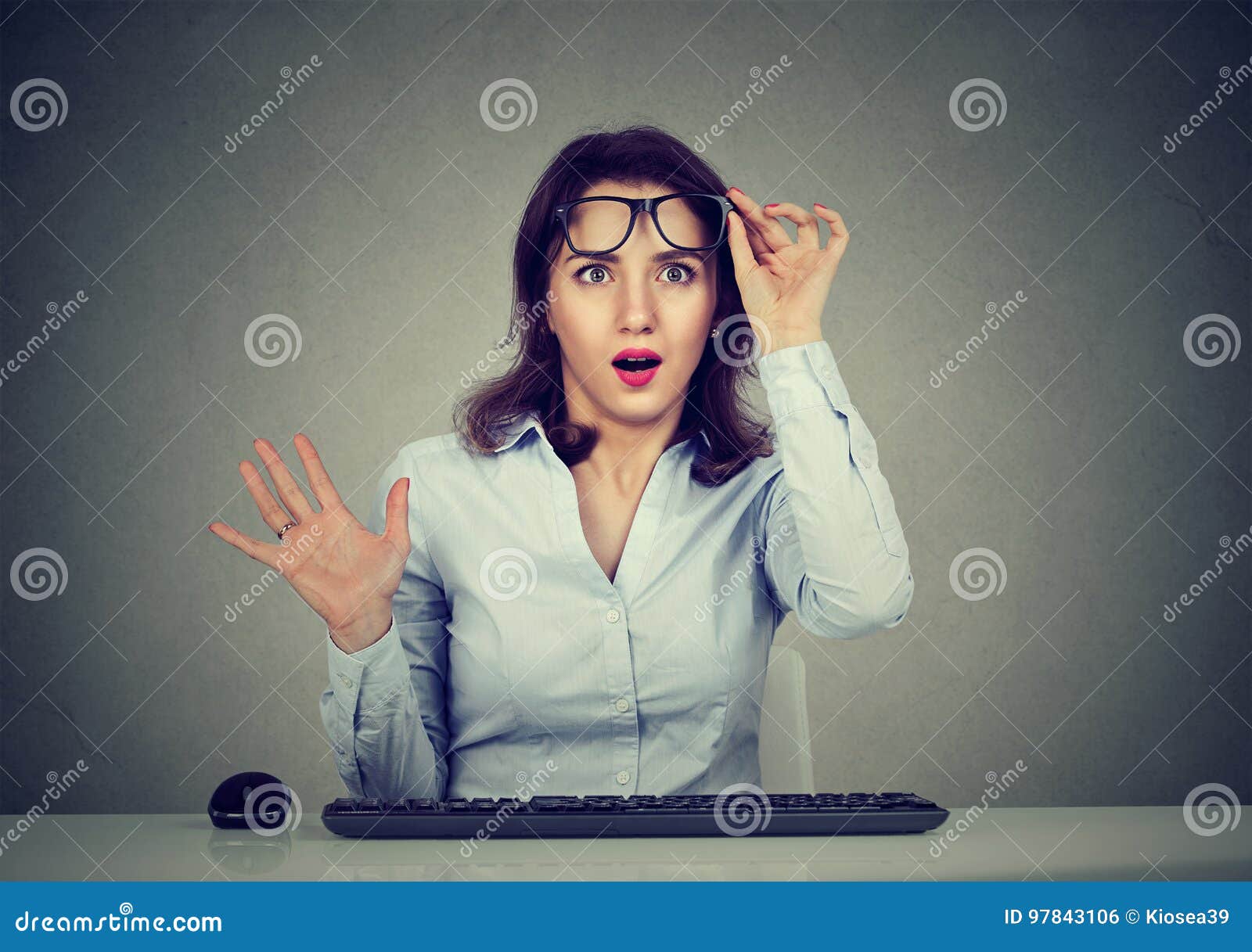Amazed Woman Working on Computer with Keyboard Looking in Surprise at ...