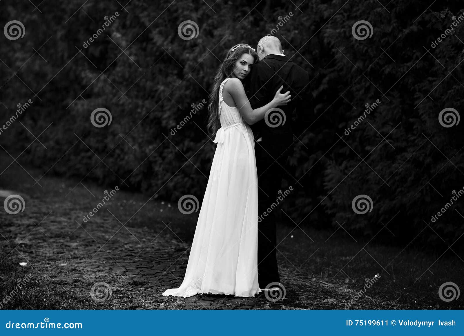 Amazing Bride Hugs a Groom Looking Over His Shoulder Stock Image ...