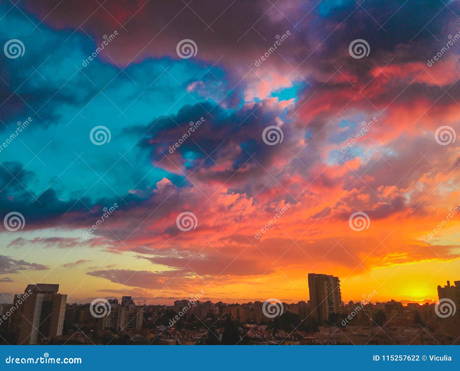 An Amazing Dramatic Cloudy Sunset Over the City and a Beautiful ...