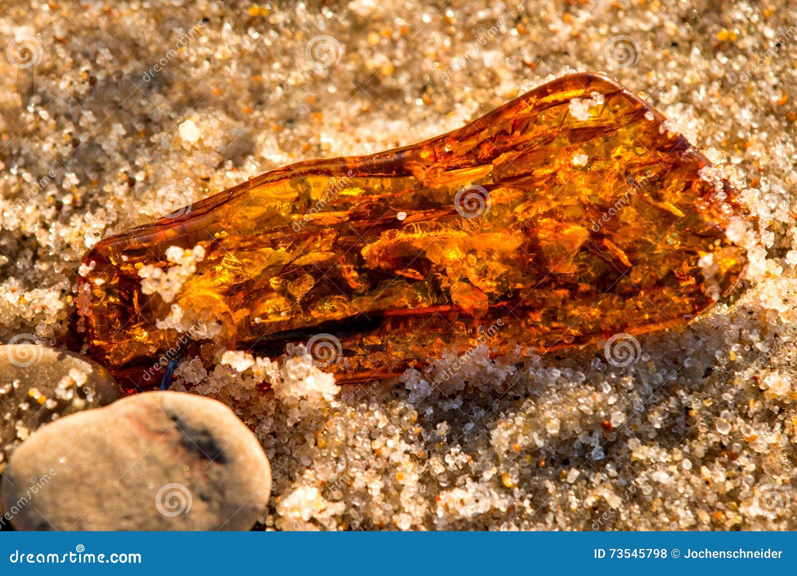 Amber on a beach stock photo. Image of shine, shiny, sand - 73545798