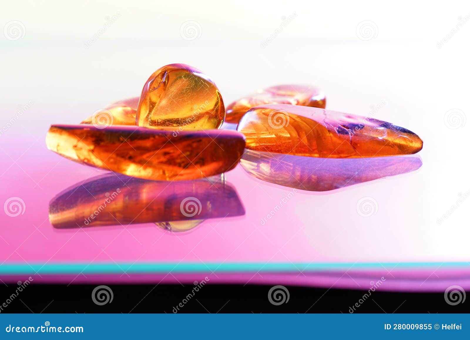 Amber Gemstone on Pink and Blue Background. Shallow Stock Image - Image ...