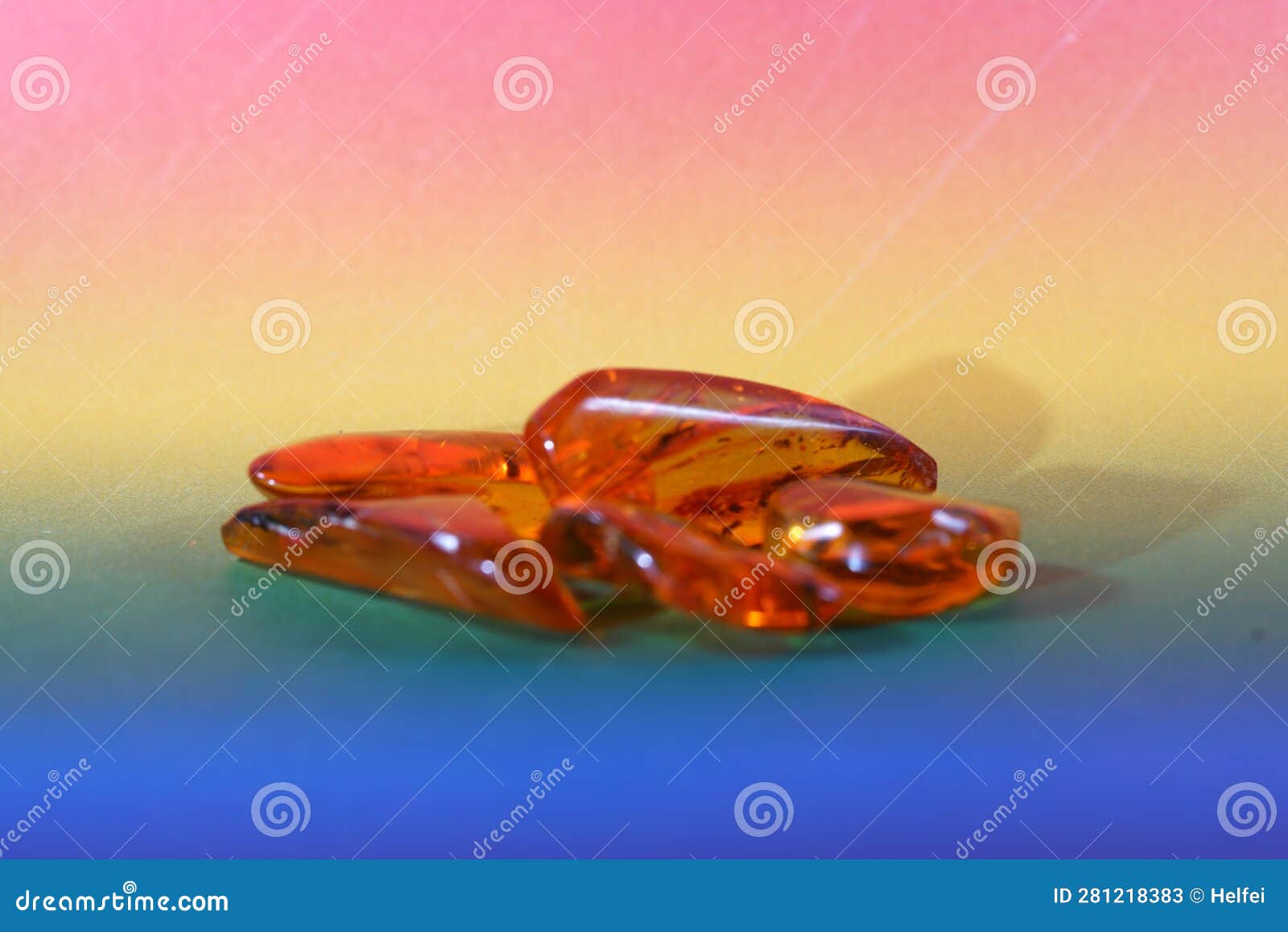 Amber Gemstone on Pink and Blue Background. Shallow Stock Image - Image ...