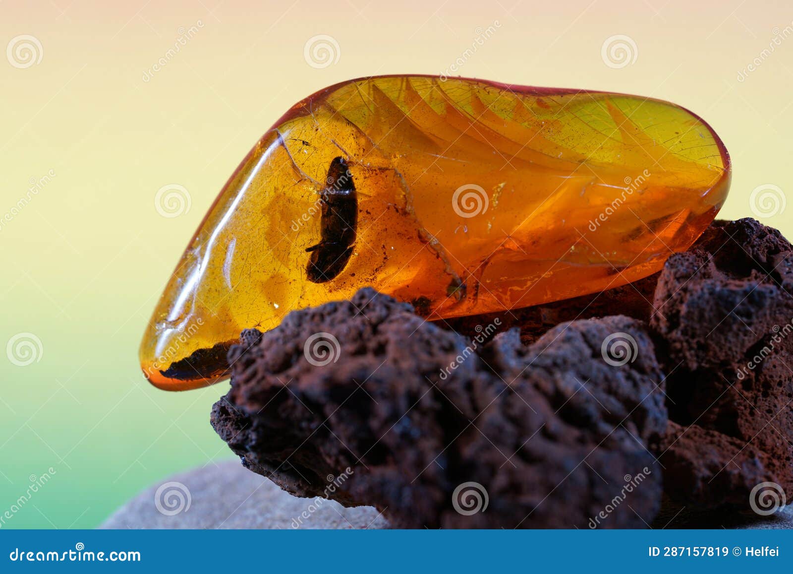 Amber Gemstone on Pink and Blue Background. Shallow Stock Image - Image ...