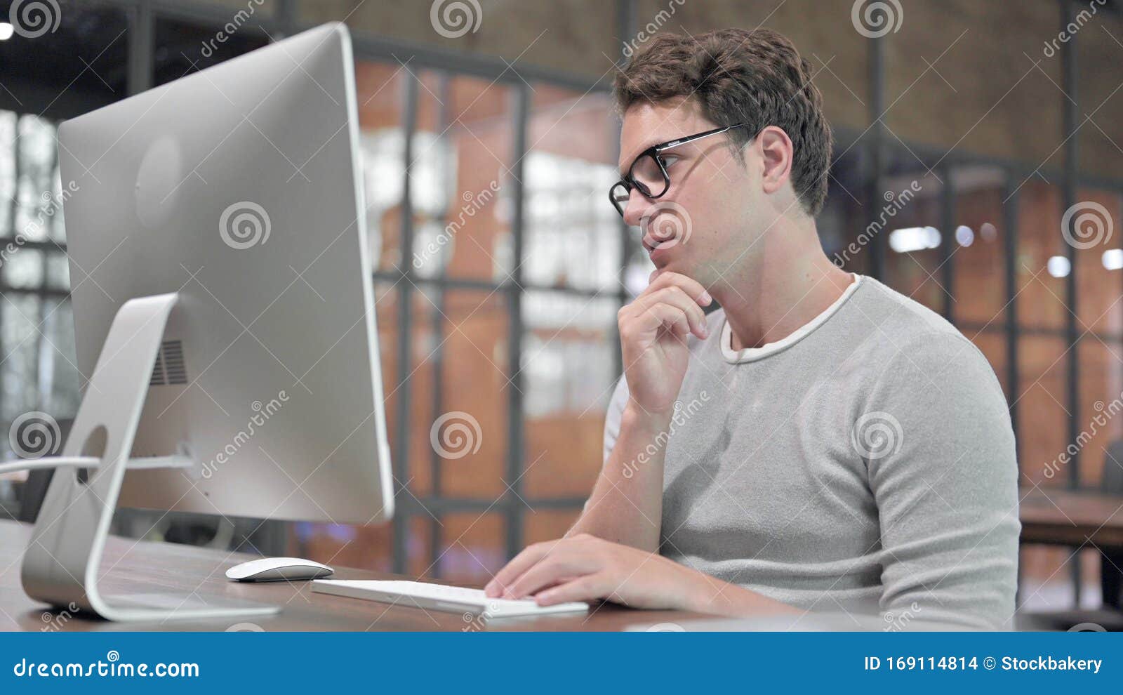 Ambitious Young Guy Thinking and Working on Computer Stock Photo ...