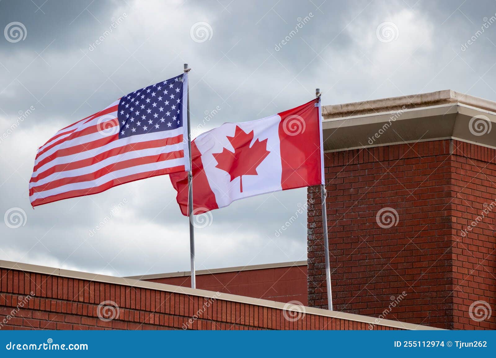 American and Canadian Flags and a Brick Building Stock Photo - Image of ...