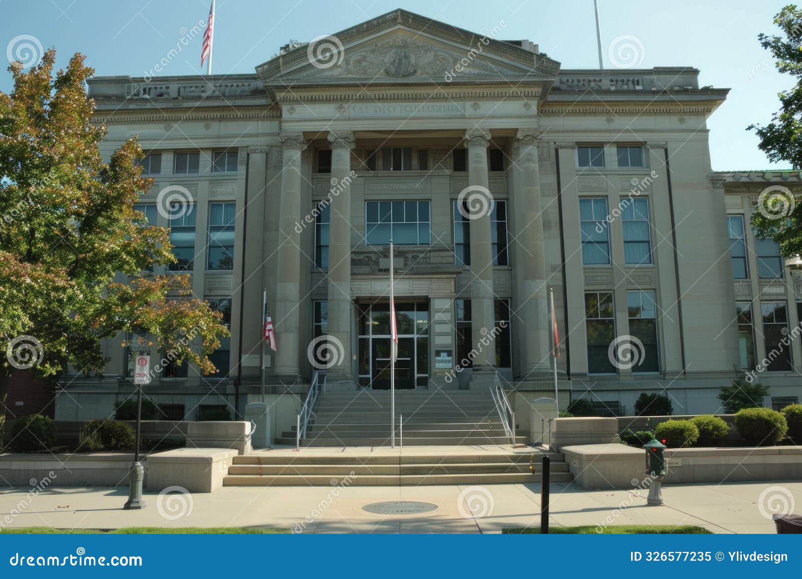 American Courthouse Building Facade with Columns and Flags Displayed on ...