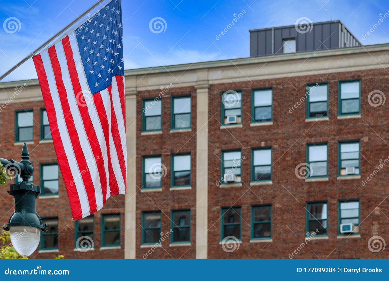 American Flag with Brick Building in Background Stock Photo - Image of ...