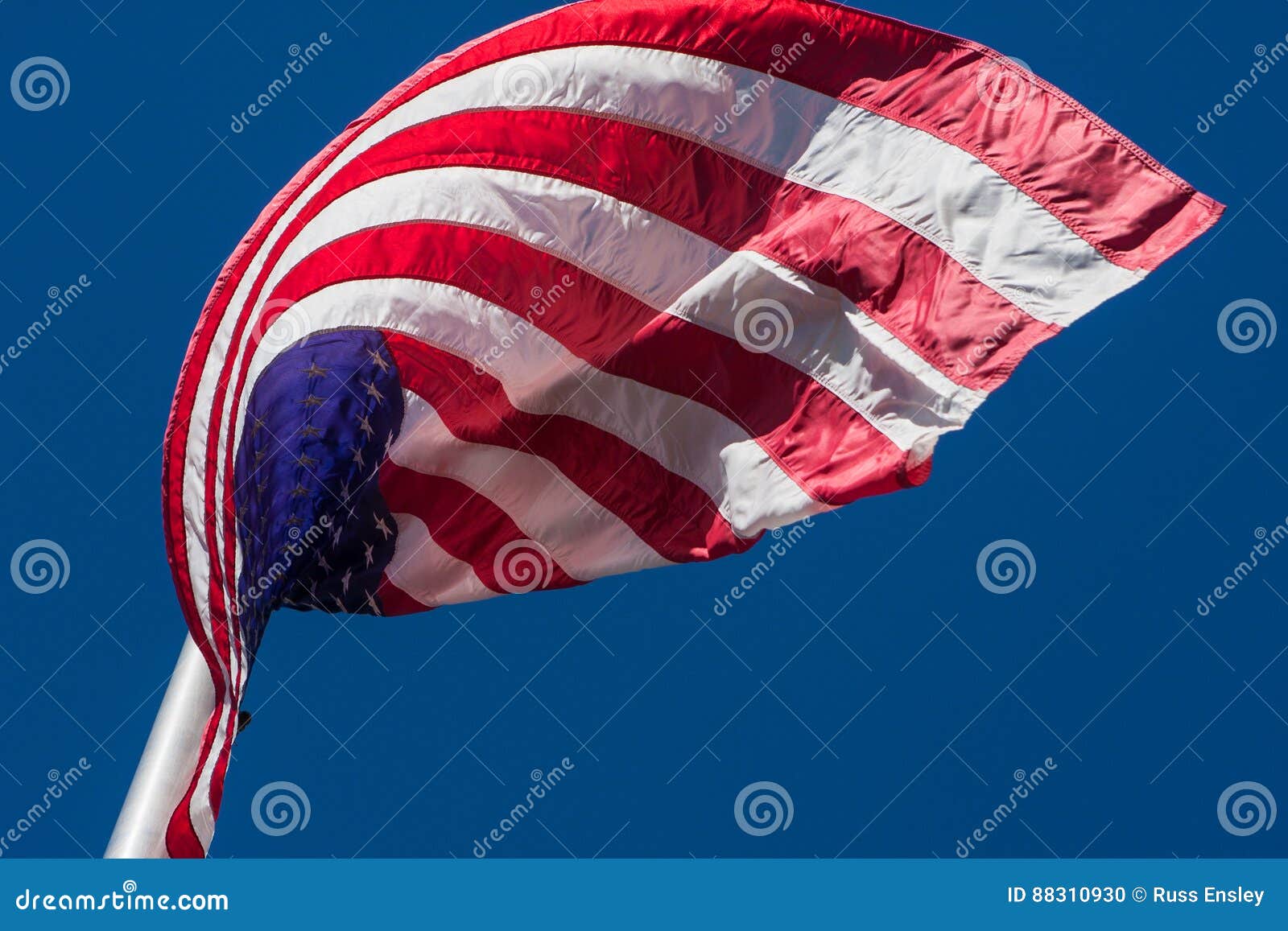 American Flag Curls in Interesting Pattern on Flagpole Stock Photo ...