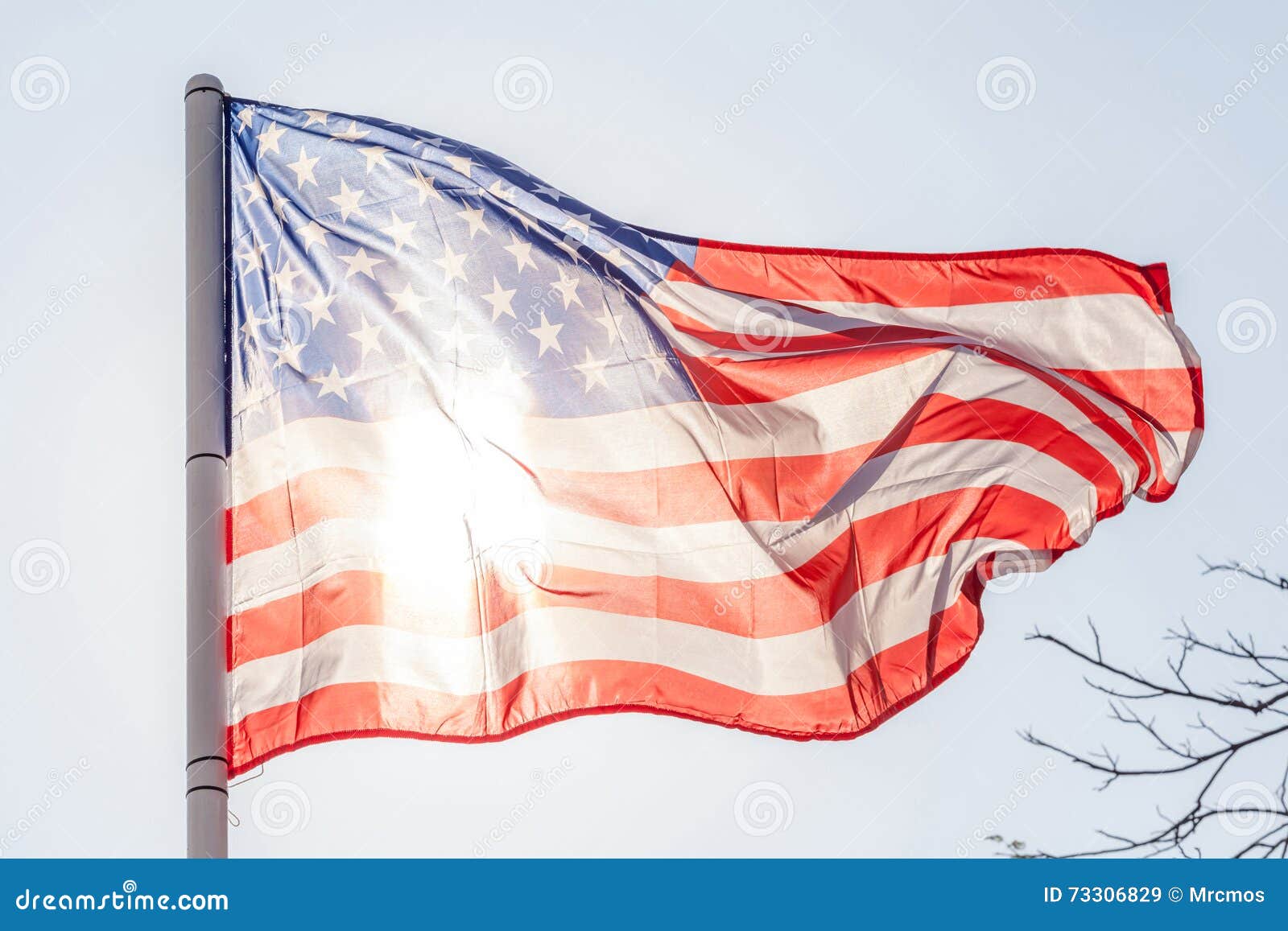 American Flag Flapping on Sky with Sunlight from Back. Stock Image ...