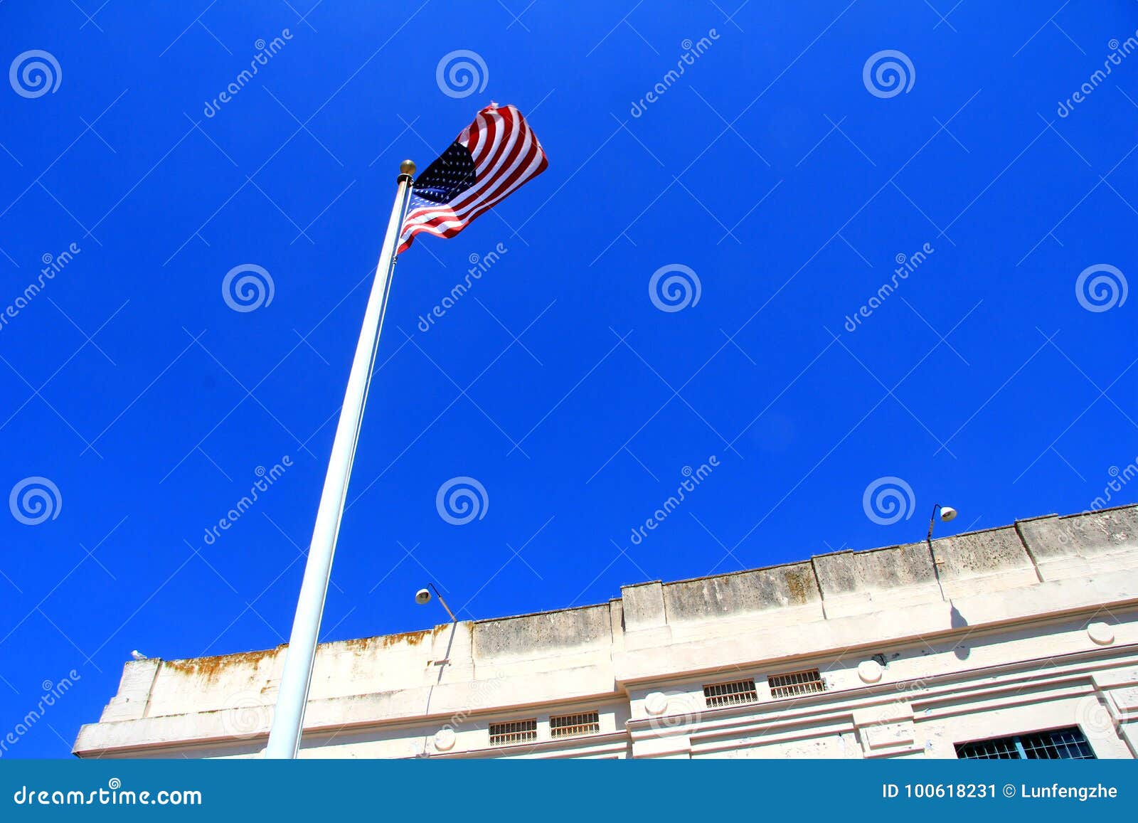 American Flag Fluttering in Front of Building Stock Image - Image of ...