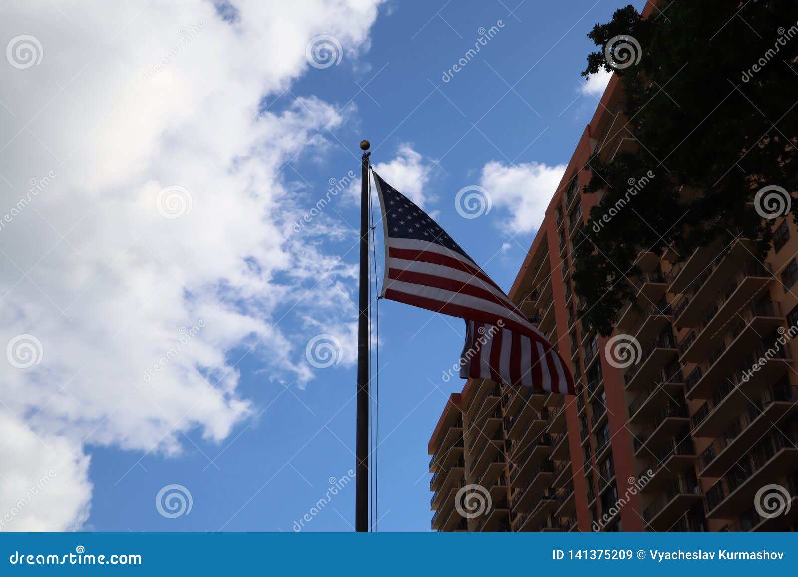 American Flag Fluttering in the Wind Against a Skyscraper Stock Image ...