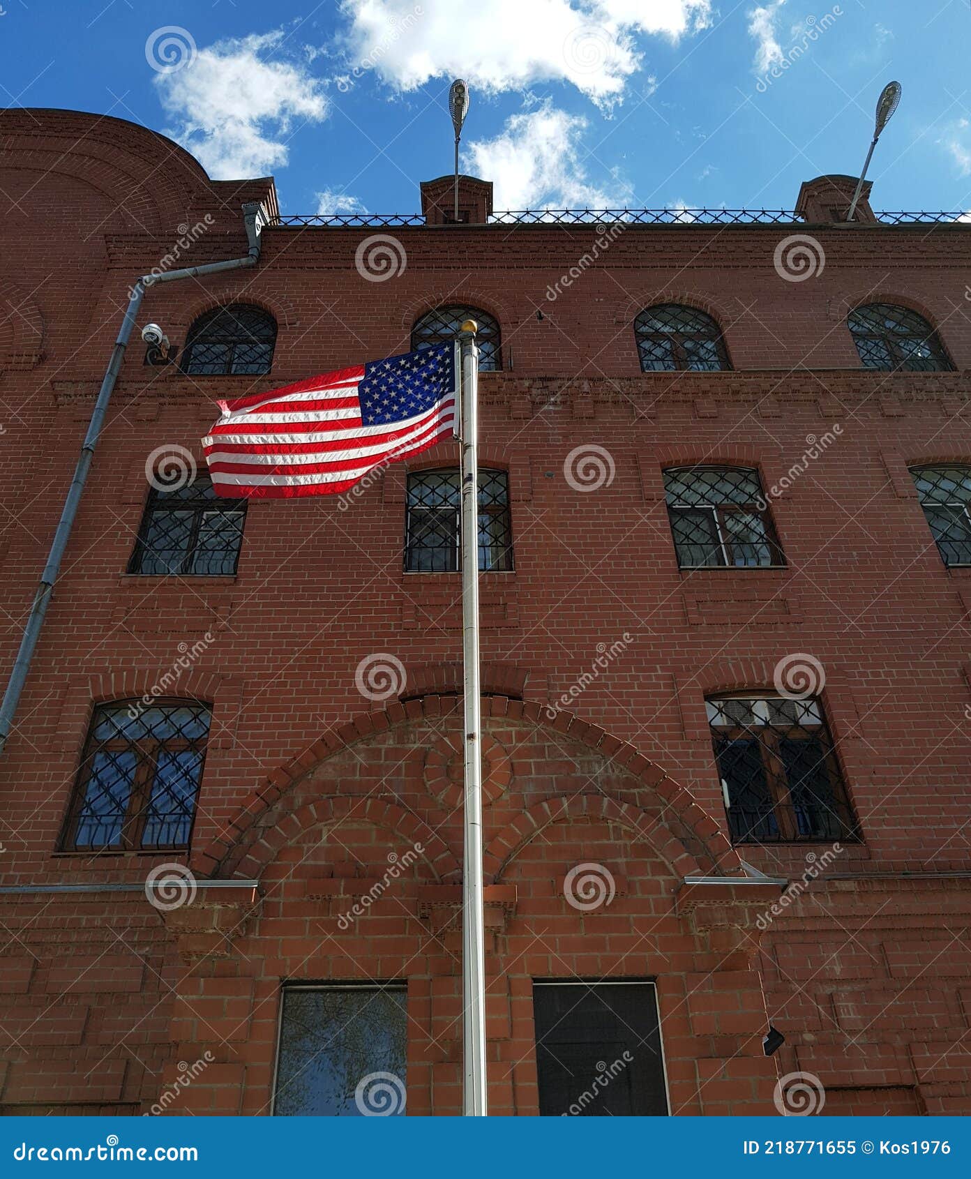 American Flag in Front of a Red Brick Building Stock Image - Image of ...