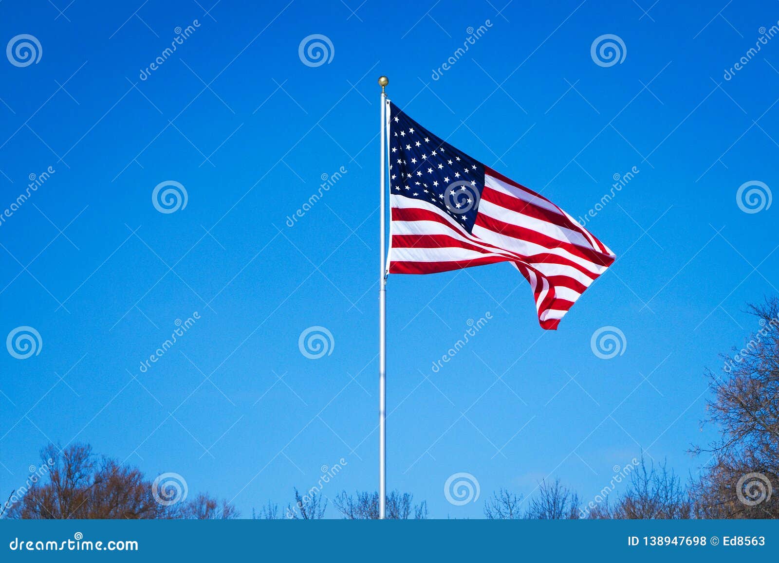 American Flag on Pole Waving in Blue Sky Stock Photo - Image of july ...