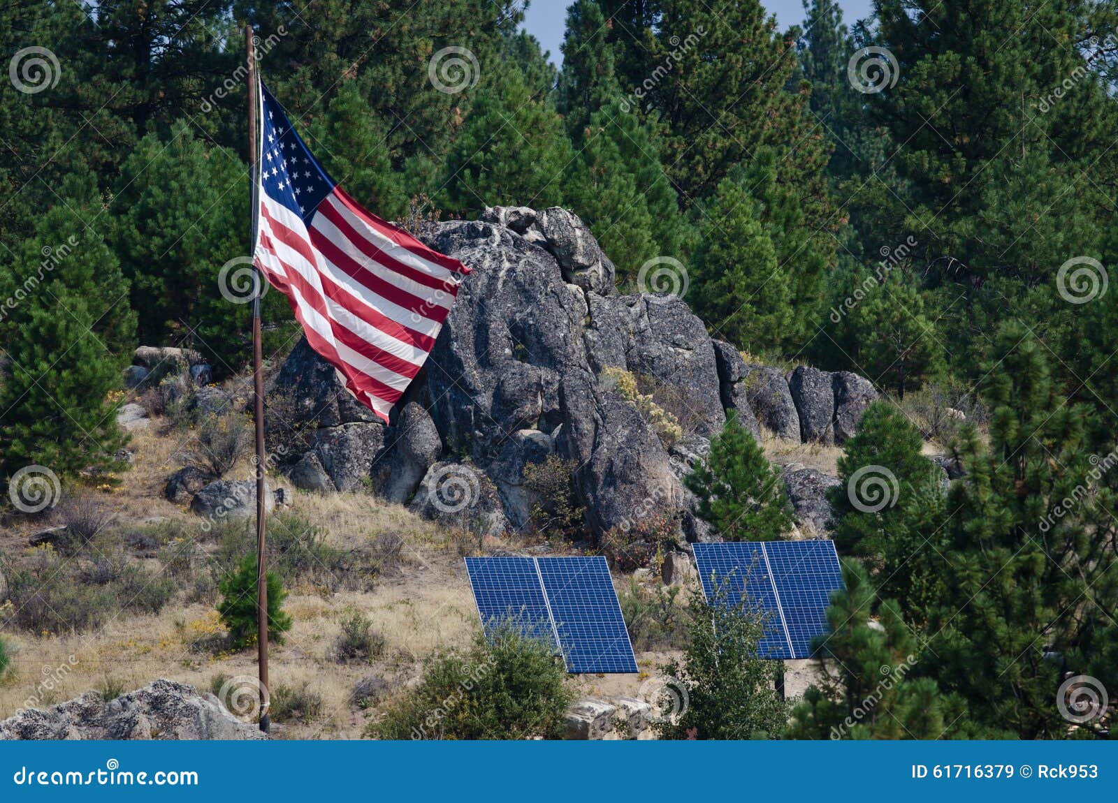American Flag Standing in the Wilderness beside Two Solar Panels Stock ...