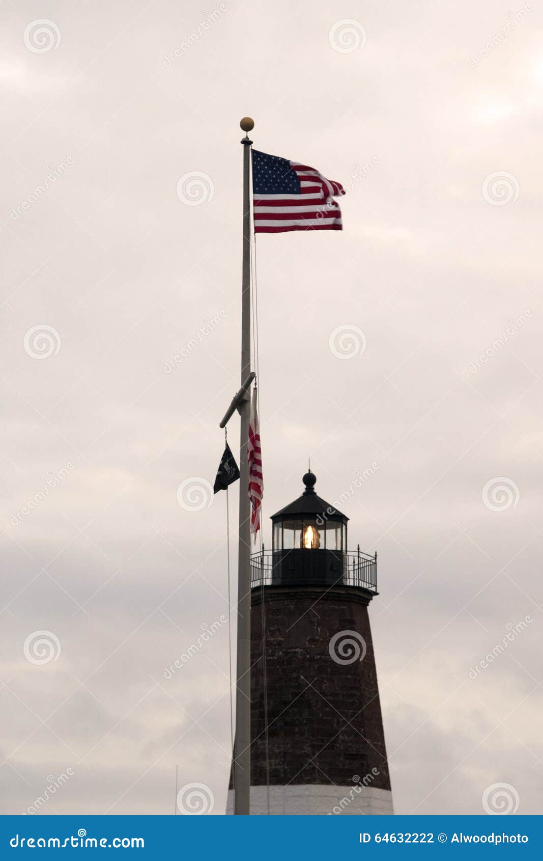 American Flag Waves Over Lighthouse Stock Photo - Image of flag ...