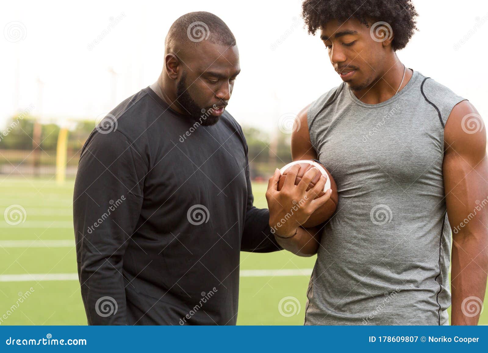 American Football Coach Training a Young Athlete. Stock Image - Image ...