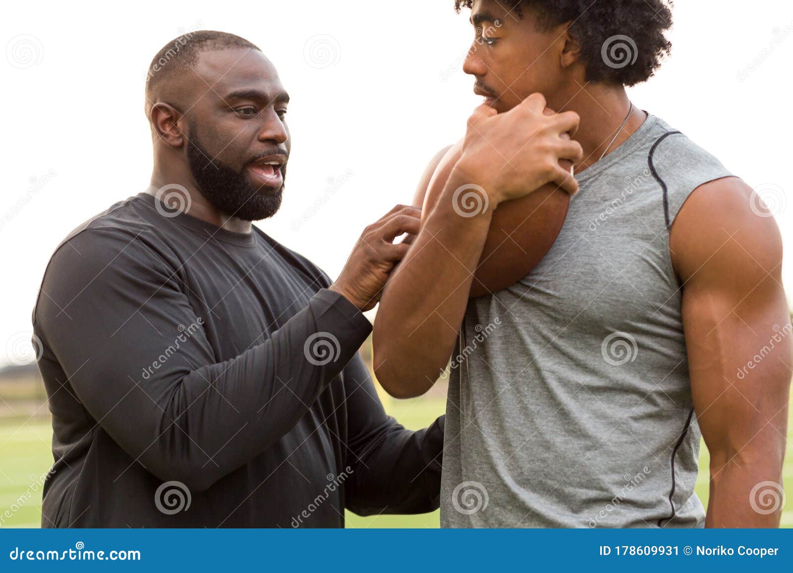 American Football Coach Training a Young Athlete. Stock Image - Image ...