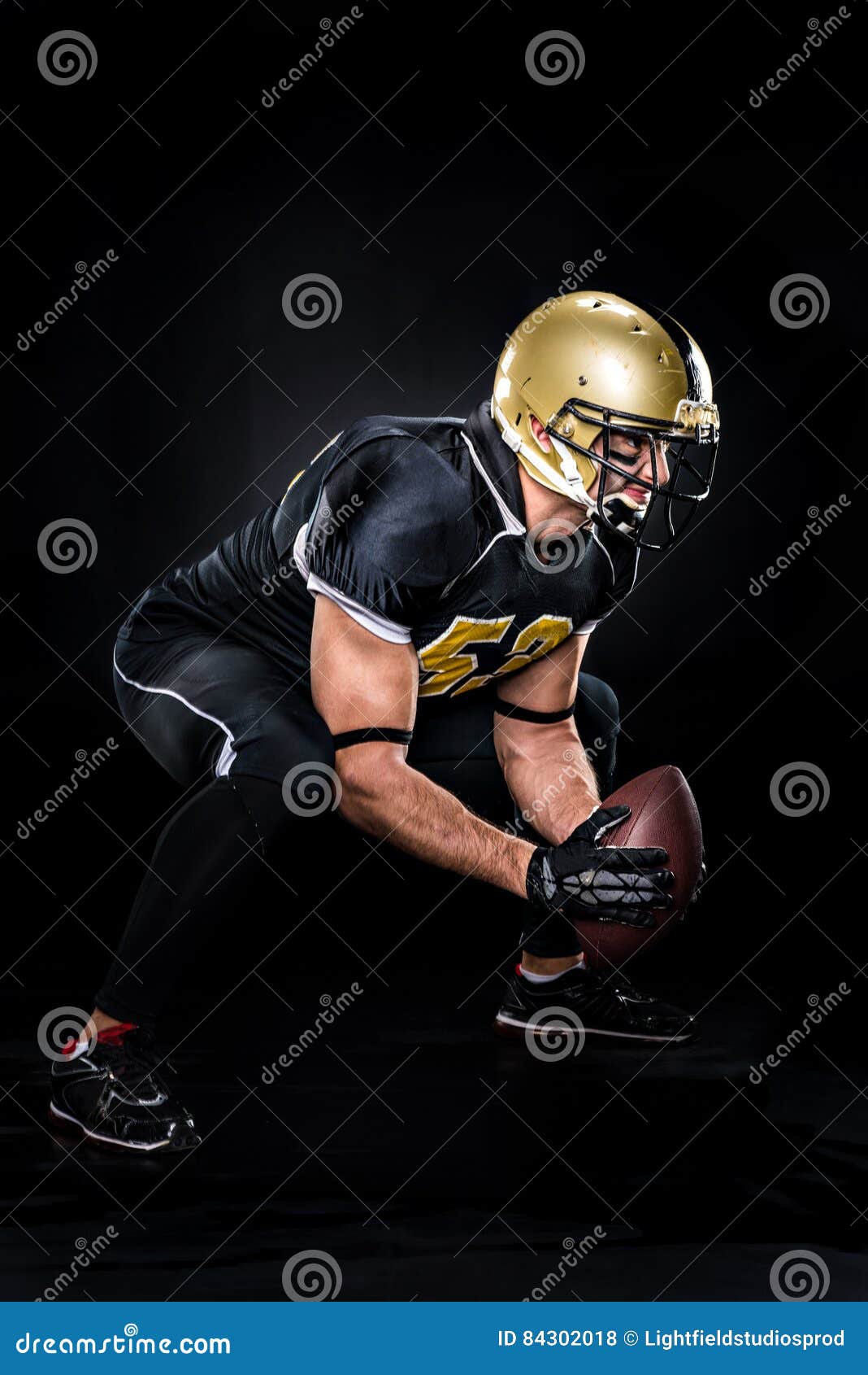 American Football Player Crouching Stock Photo - Image of dark, action ...