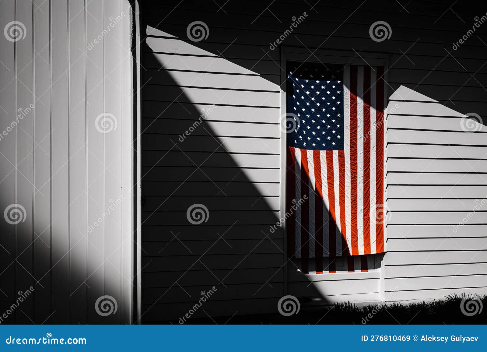An American Home Displaying Their Flag. USA Flag on the Wall Stock ...