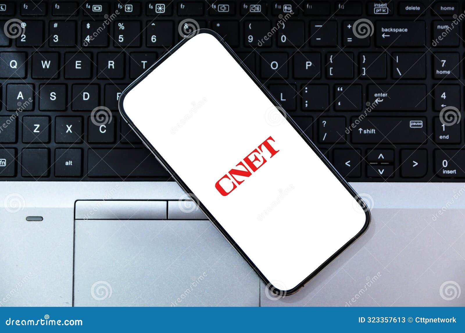 American Media Website CNET on the Mobile Screen with Laptop in the ...