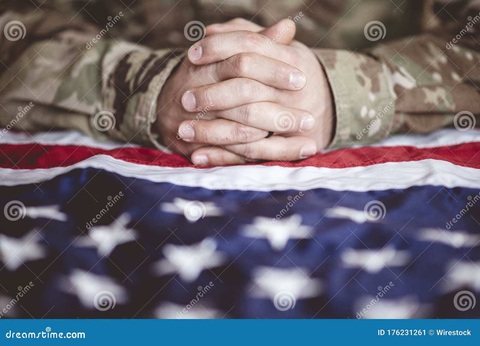 American Soldier Mourning and Praying with the American Flag in Front ...