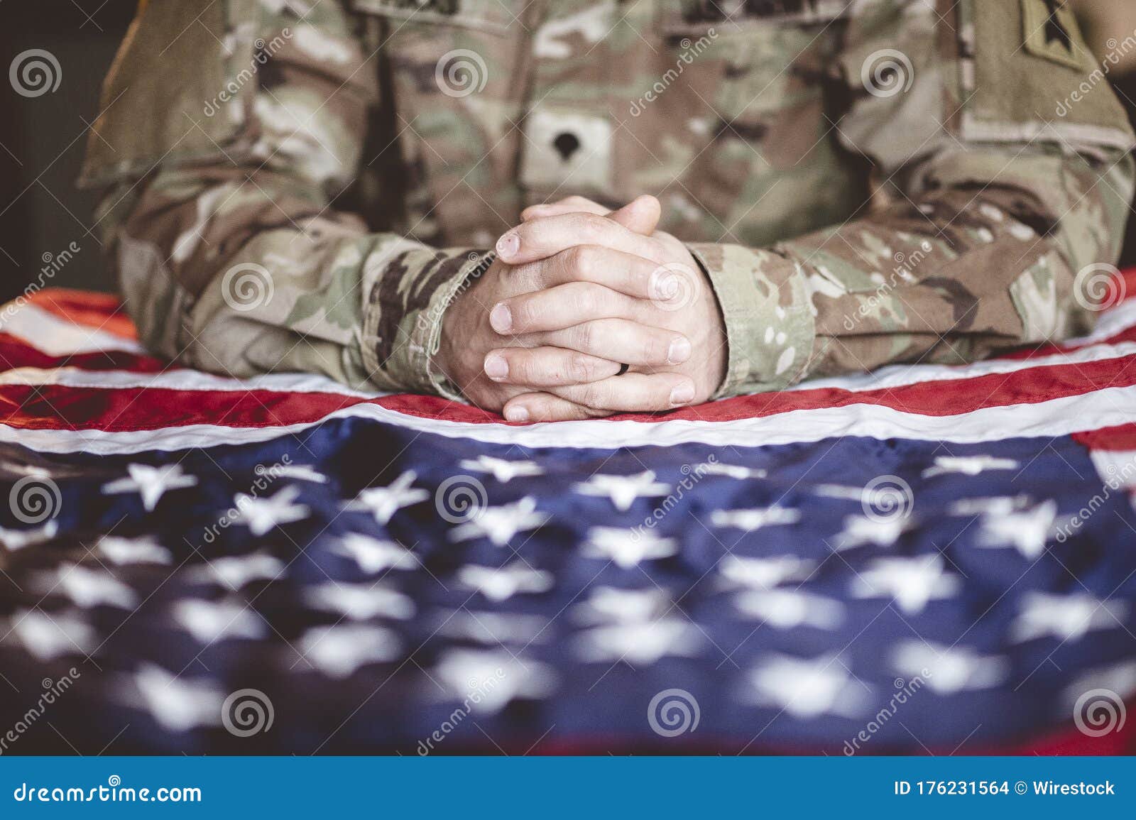 American Soldier Mourning and Praying with the American Flag in Front ...