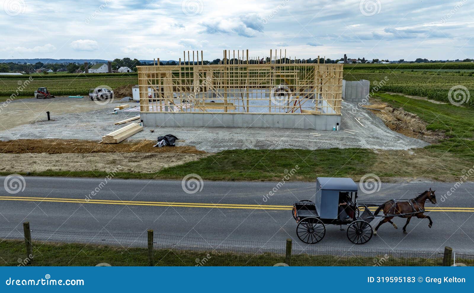 Amish Horse and Buggy Passing Construction Site of New Building Stock ...