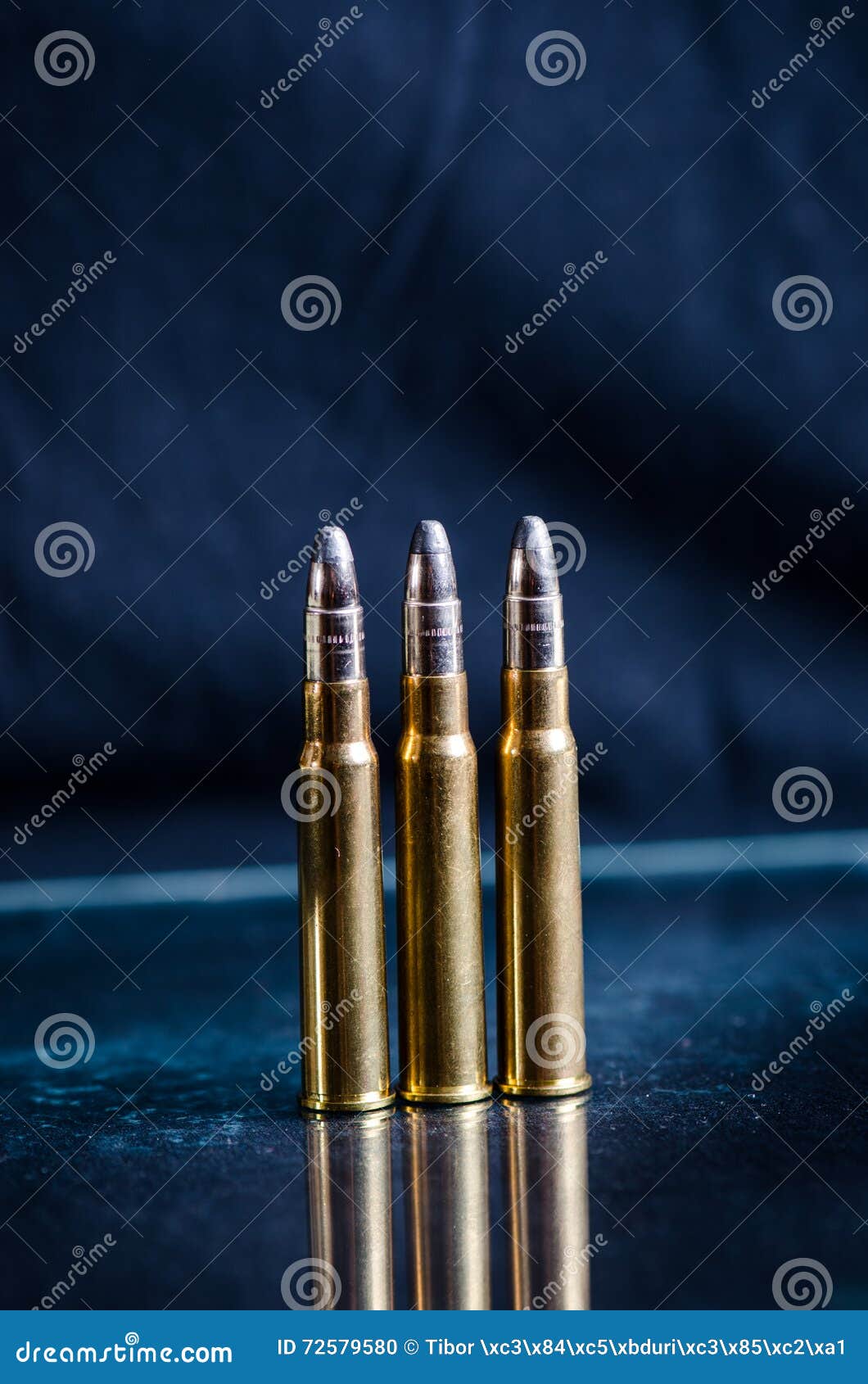 Ammunition on a Dark Blue Background with Reflection in a Glass. Close ...