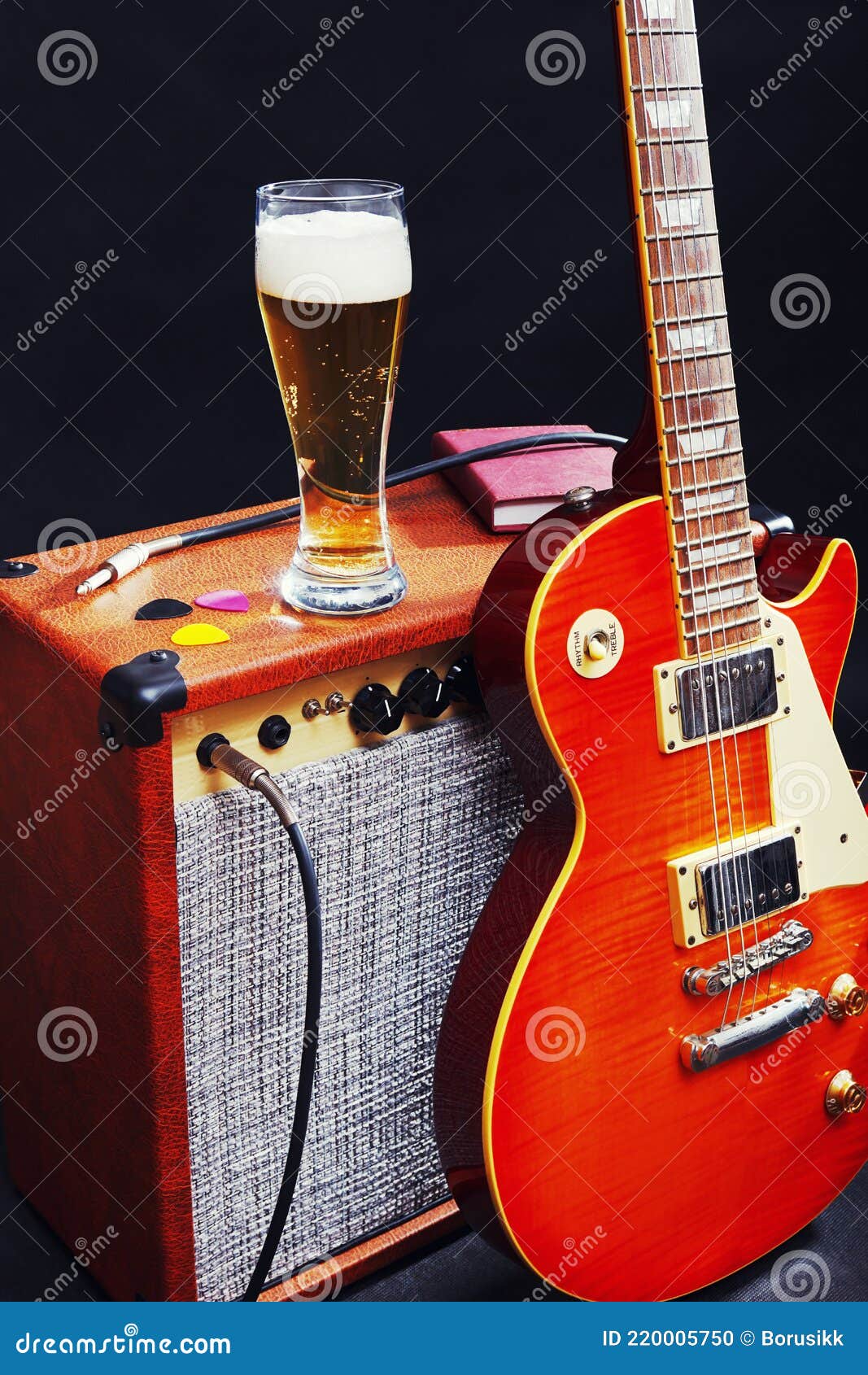 Amplifier for Guitar with Guitar, Glass of Beer and Notepad on Black ...
