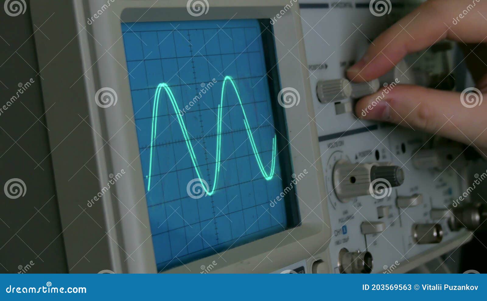 Amplitude Diagram on the Oscilloscope. a Man Presses the Buttons on the ...