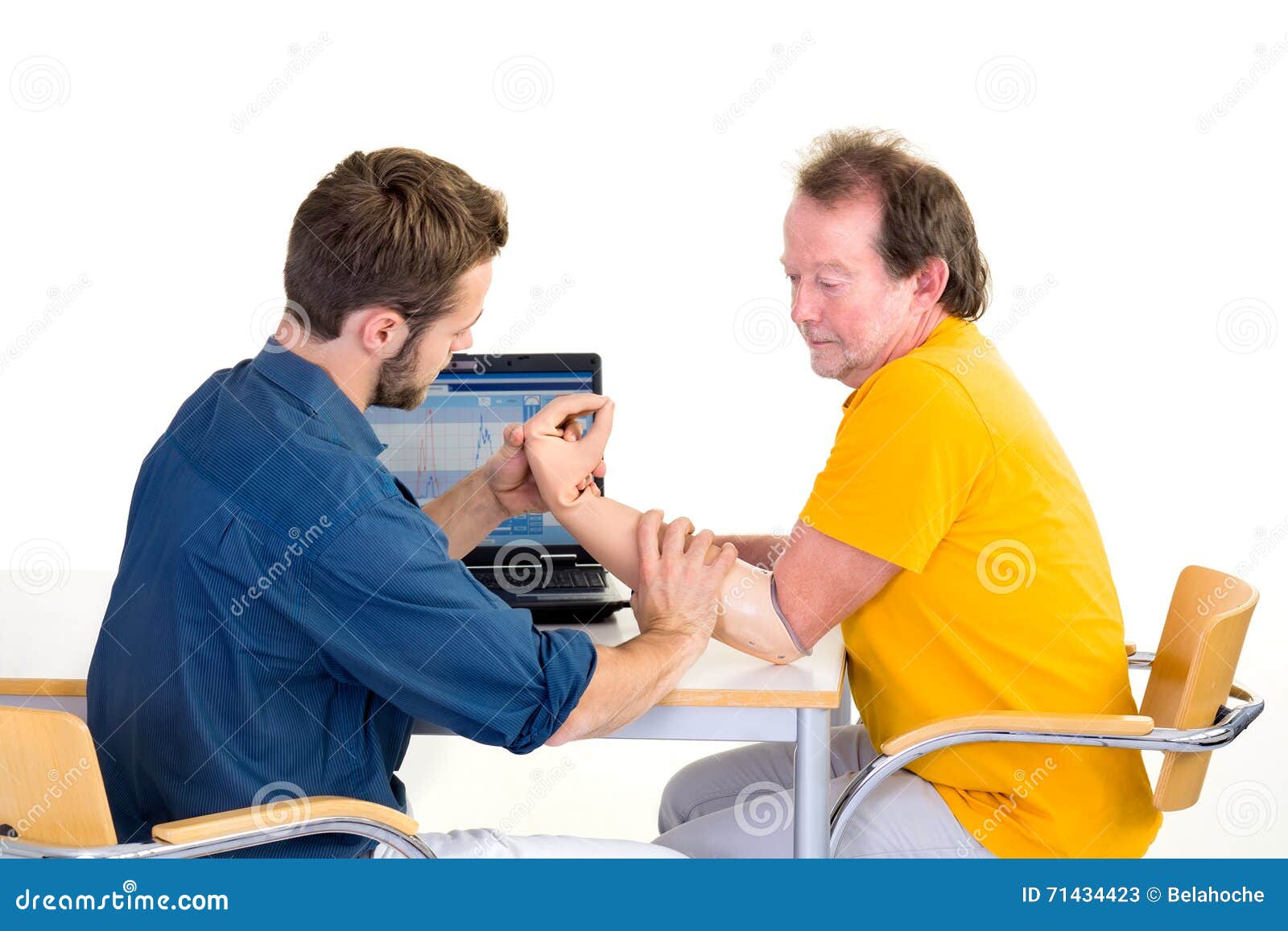 Amputee Works with Medical Professional at Table. Testing Function of ...