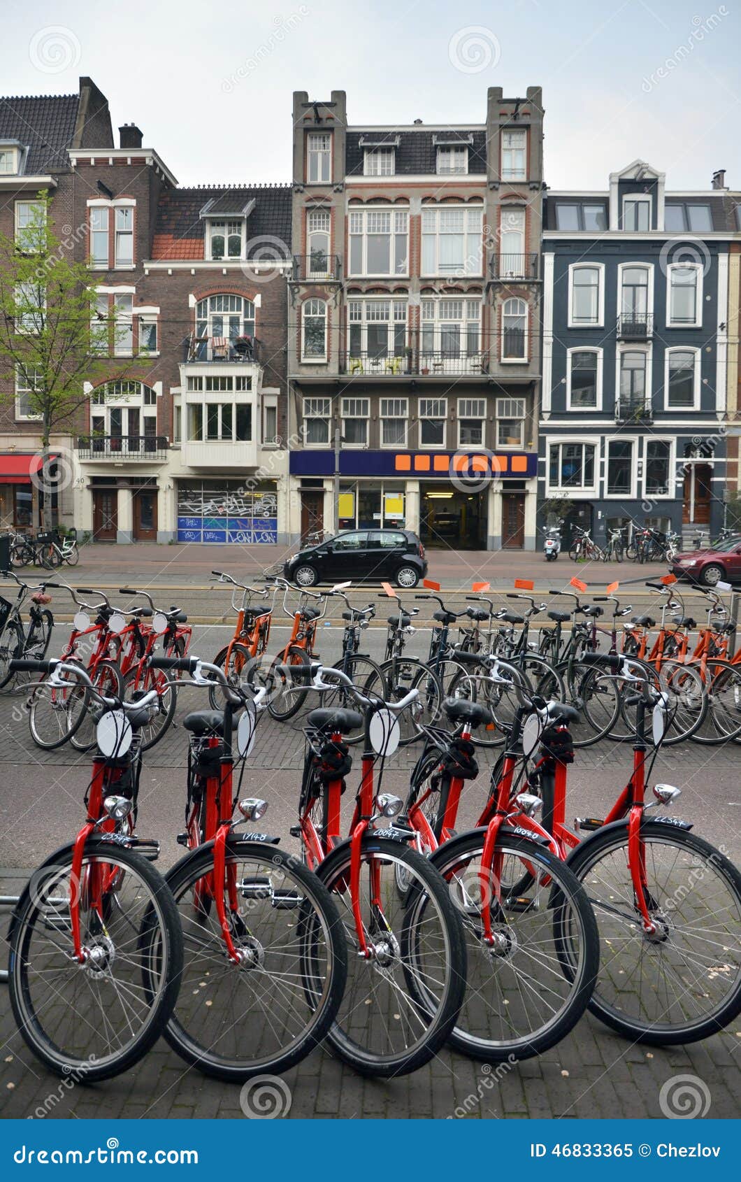 Amsterdam Bikes At Sidewalk With Houses On Background Stock Photography ...