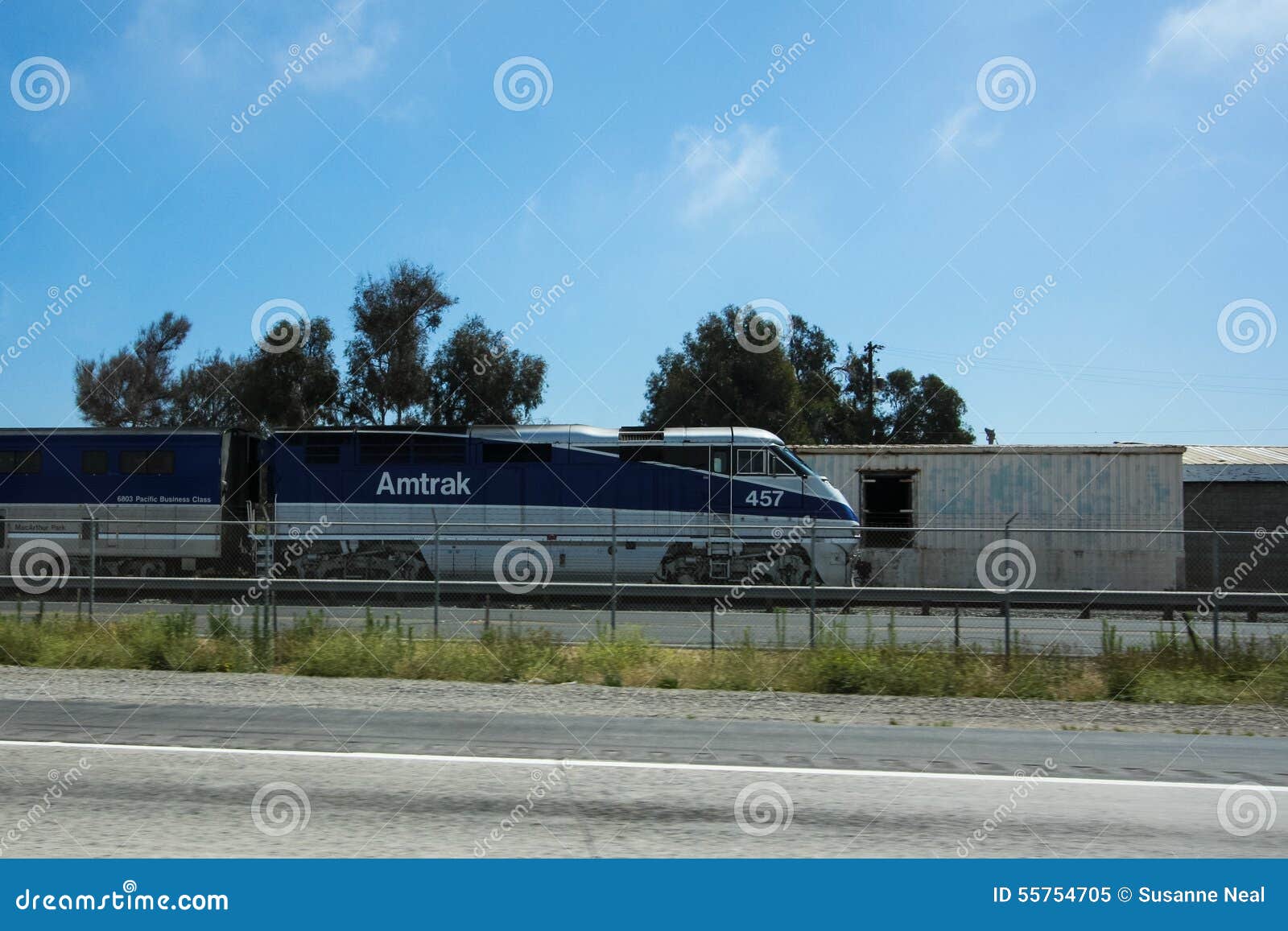 Amtrak Train Rolling Down the Rails beside Freeway Editorial Image ...