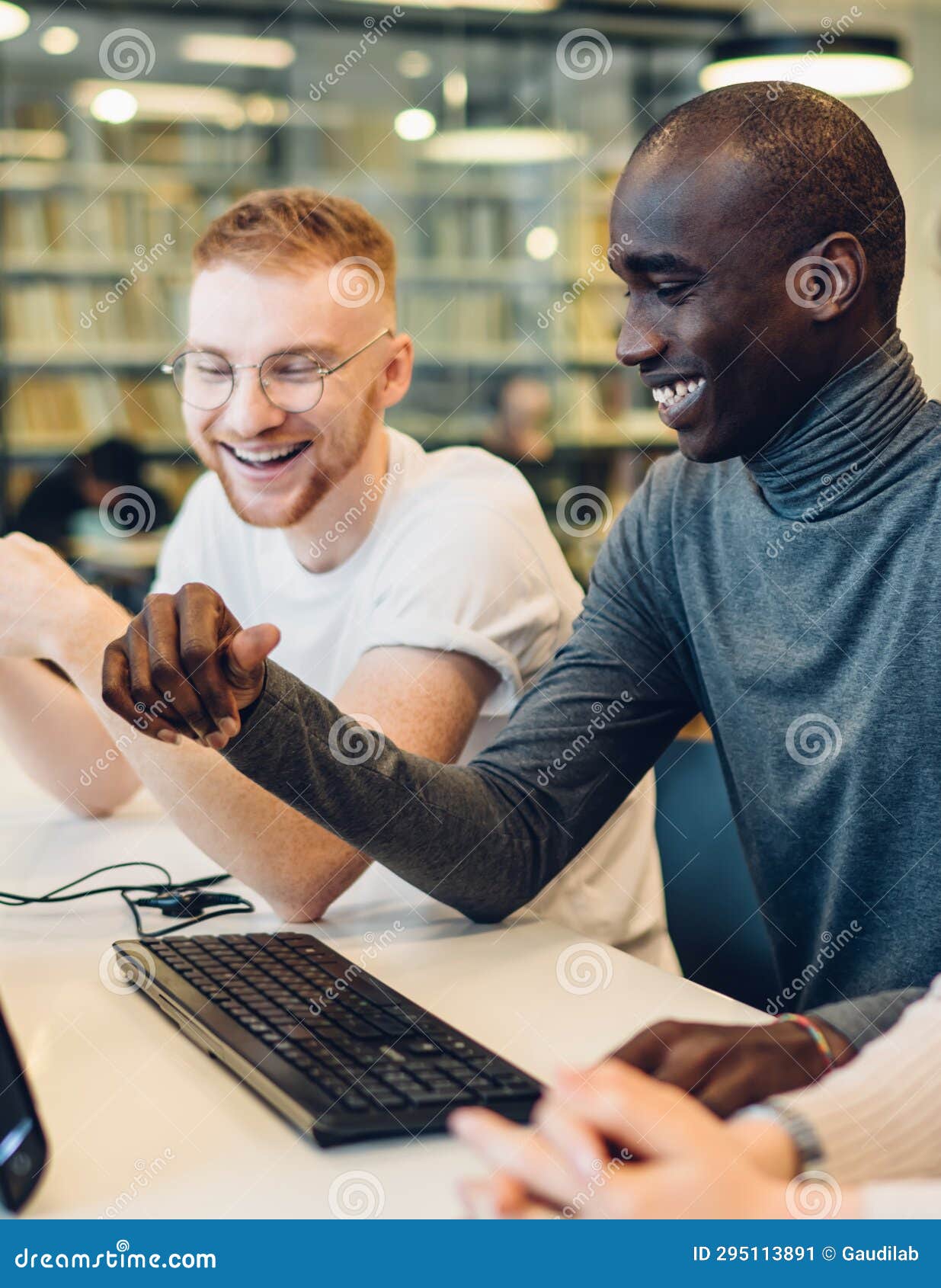 Amused Multiracial Students Having Fun while Using Computer in Library ...