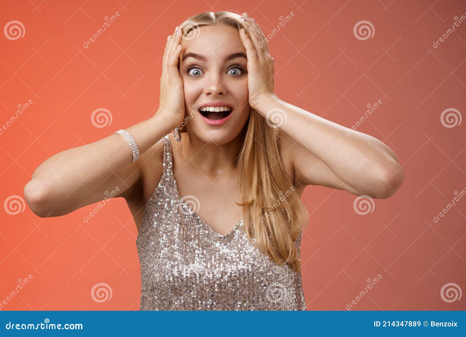 Amused Surprised Excited Young Blond Attractive Woman In Silver