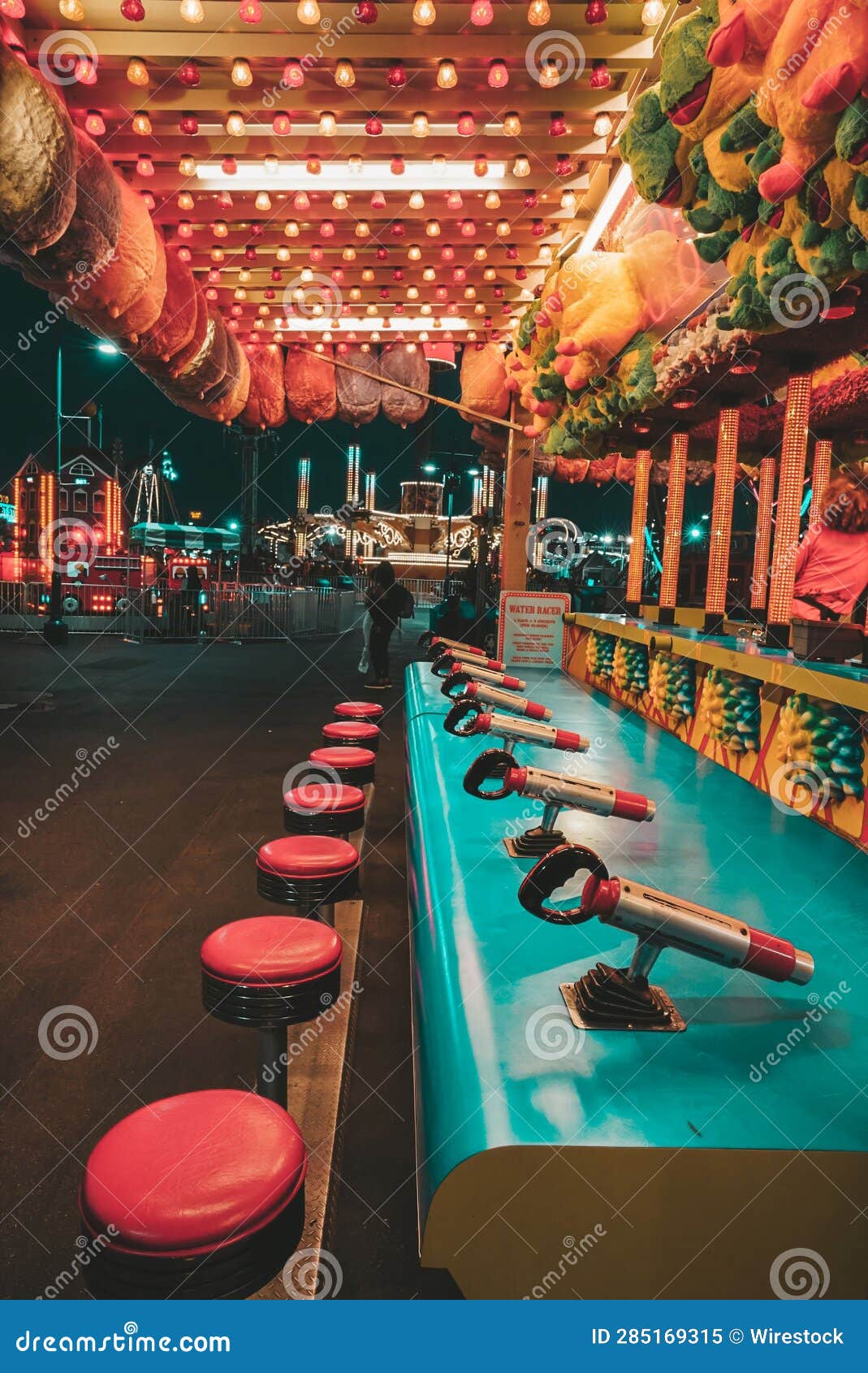 An Amusement Arcade Covered in Lots of Stools and Neon Lights Stock ...