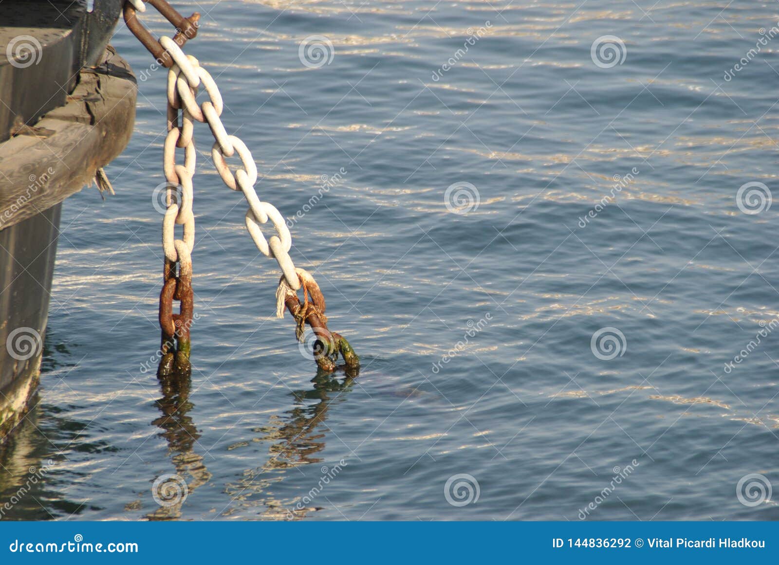 Anchor chain on the water stock photo. Image of anchorage - 144836292