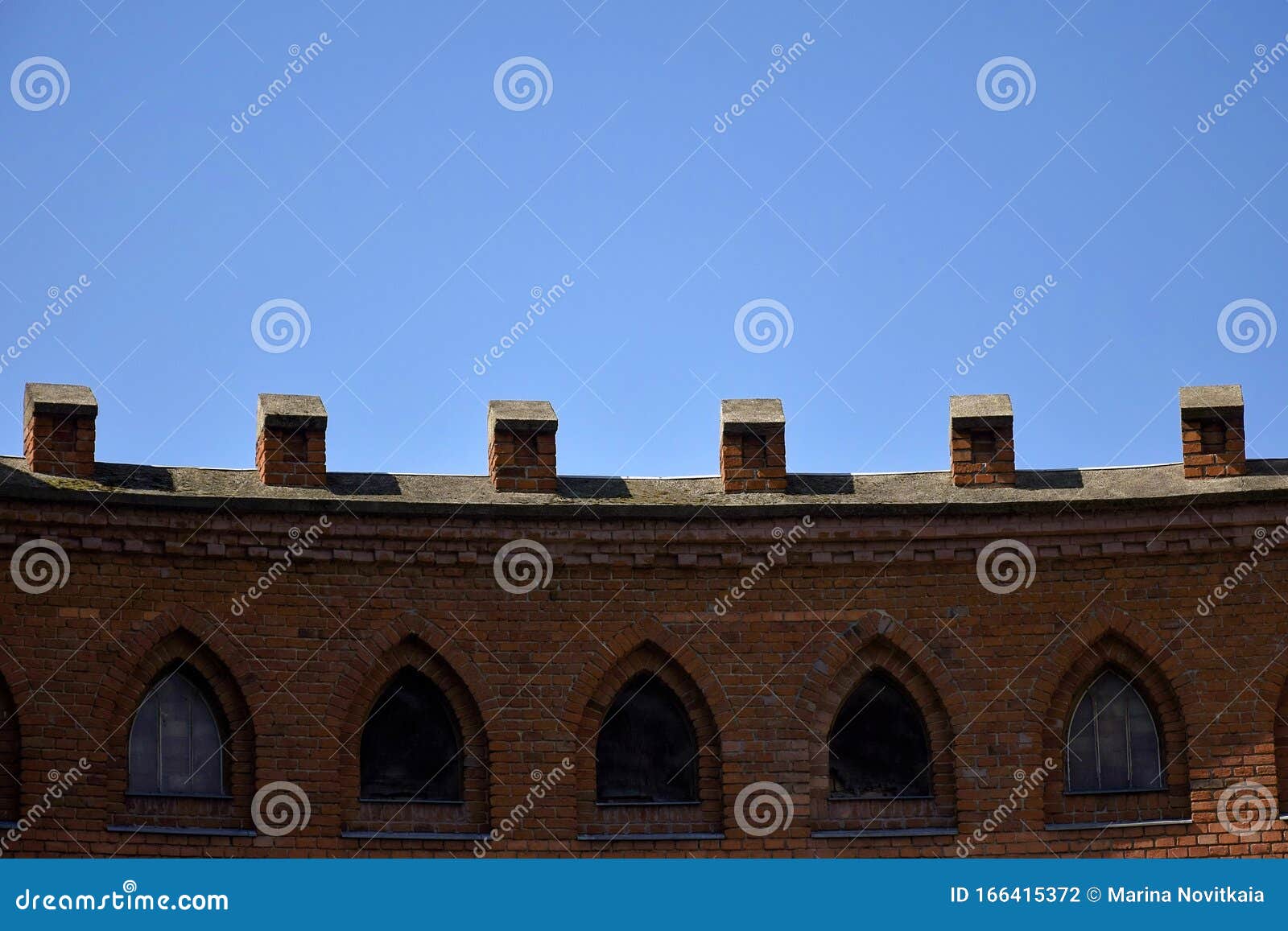 Ancient Brick Building with Arched Windows on a Background of Blue ...
