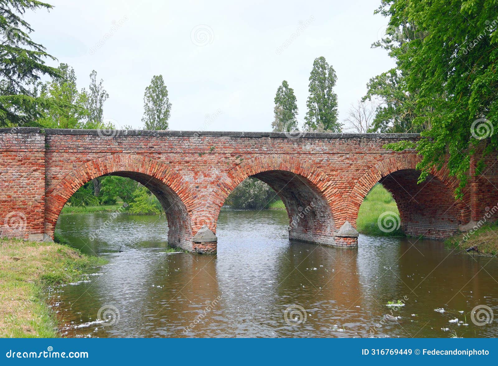 Ancient Bridge with Three Arches Over the Small River Made with Bricks ...