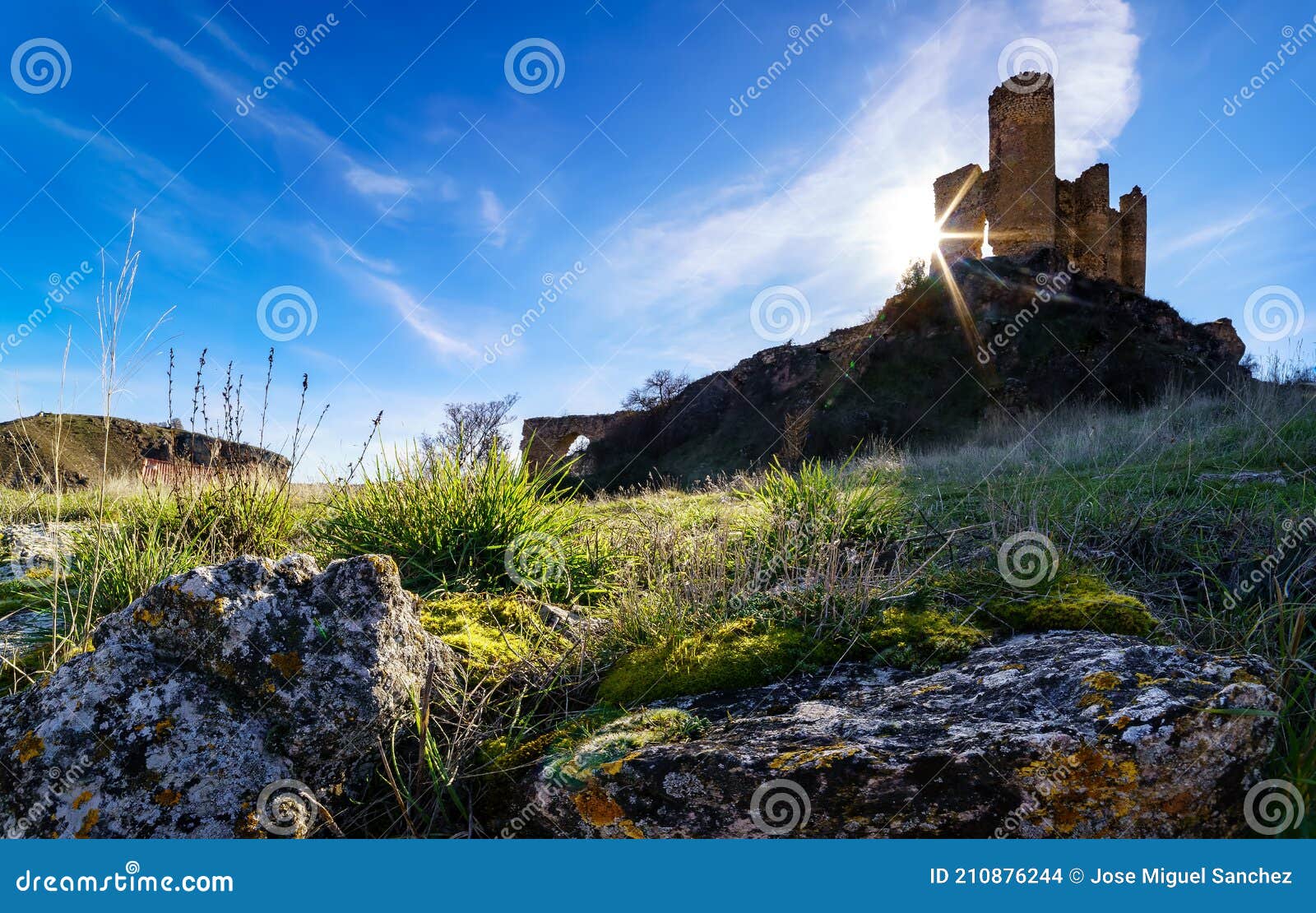 Ancient Castle Ruins in Landscape with Rocks, Grass and Sun Scending ...
