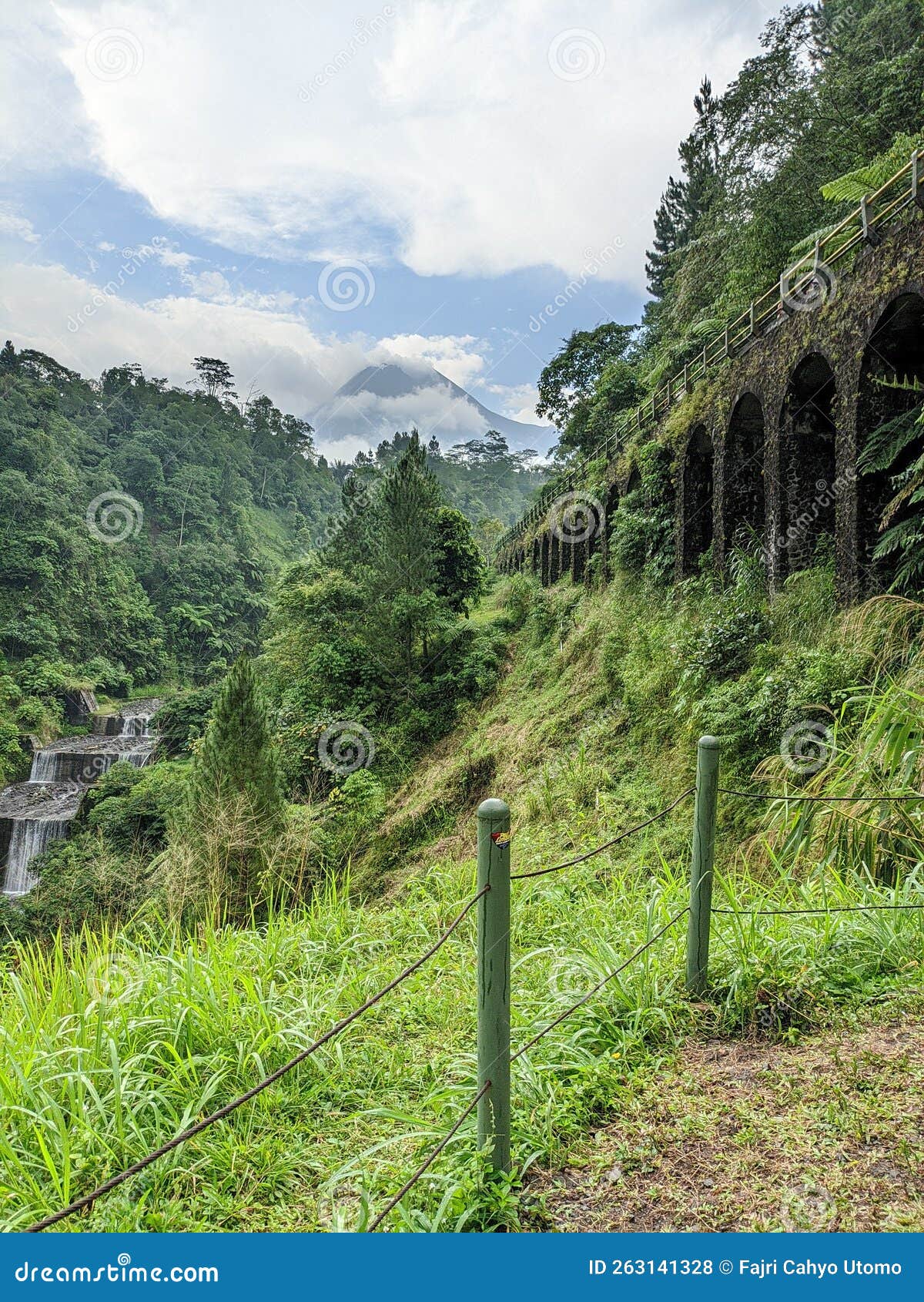 An Ancient Colonial Bridge with a View of the Volcanic Mount Merapi ...
