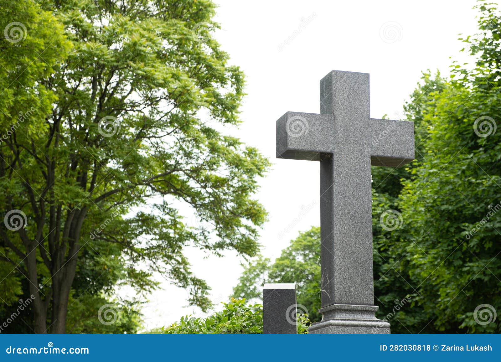 An Ancient Cross in the Cemetery Against the Background of Trees and ...